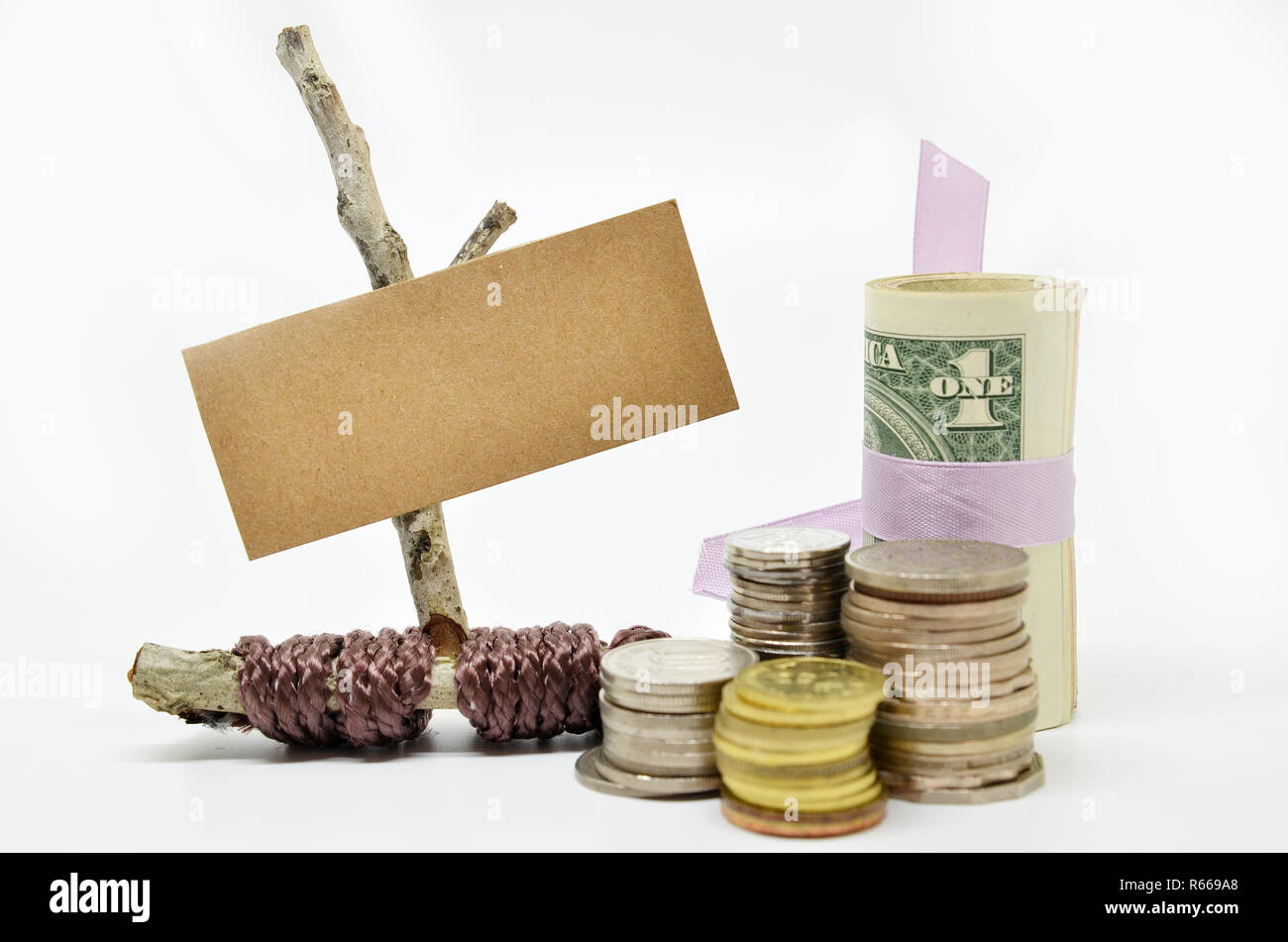 Paper sign board with stack of coins Stock Photo - Alamy
