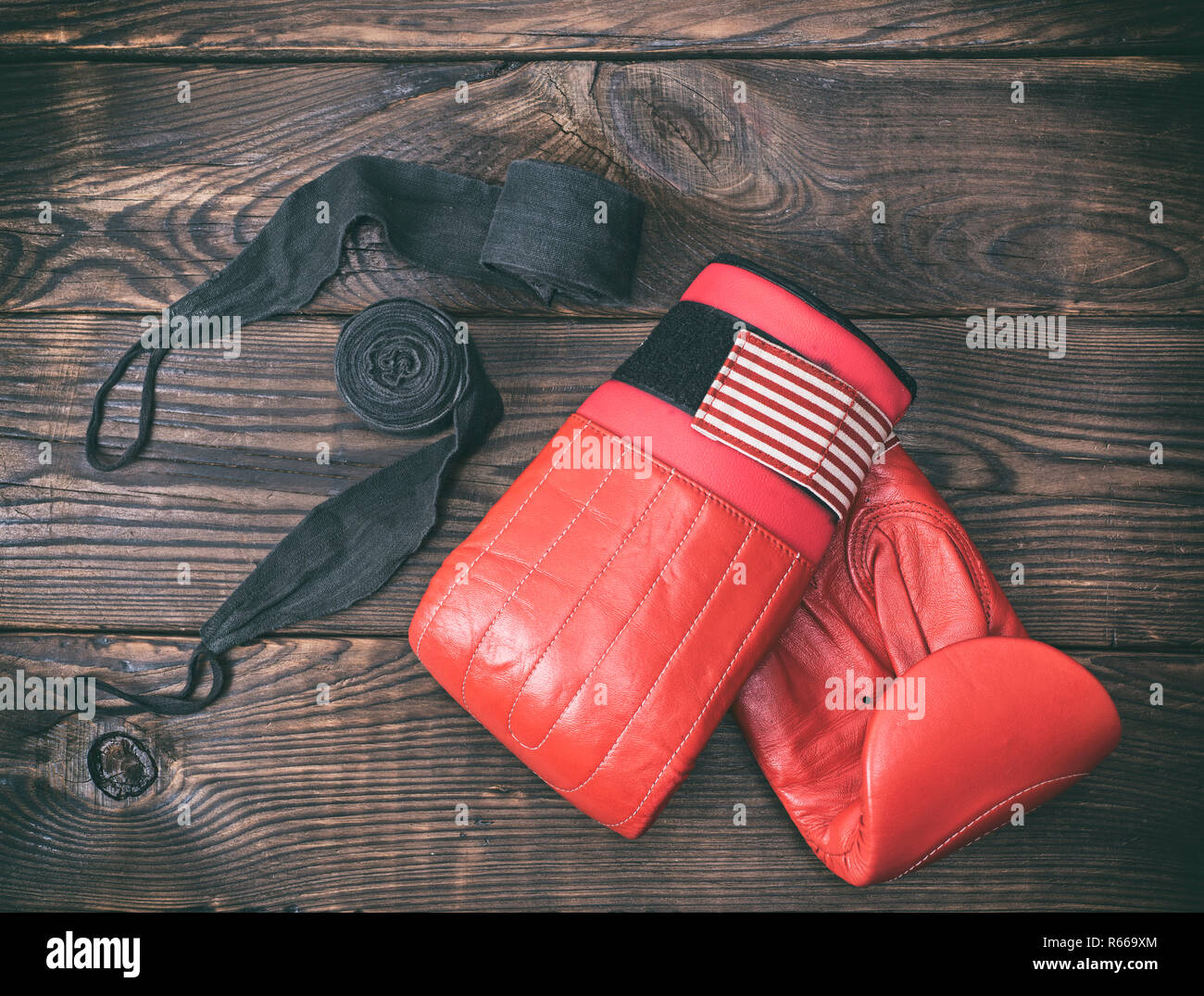 red leather boxing gloves and black bandage Stock Photo - Alamy