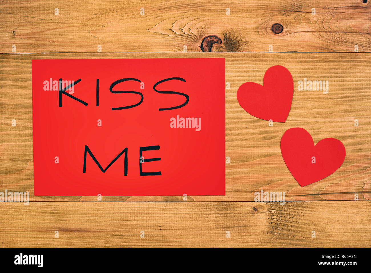 Red paper with word kiss me and heart shapes Stock Photo - Alamy