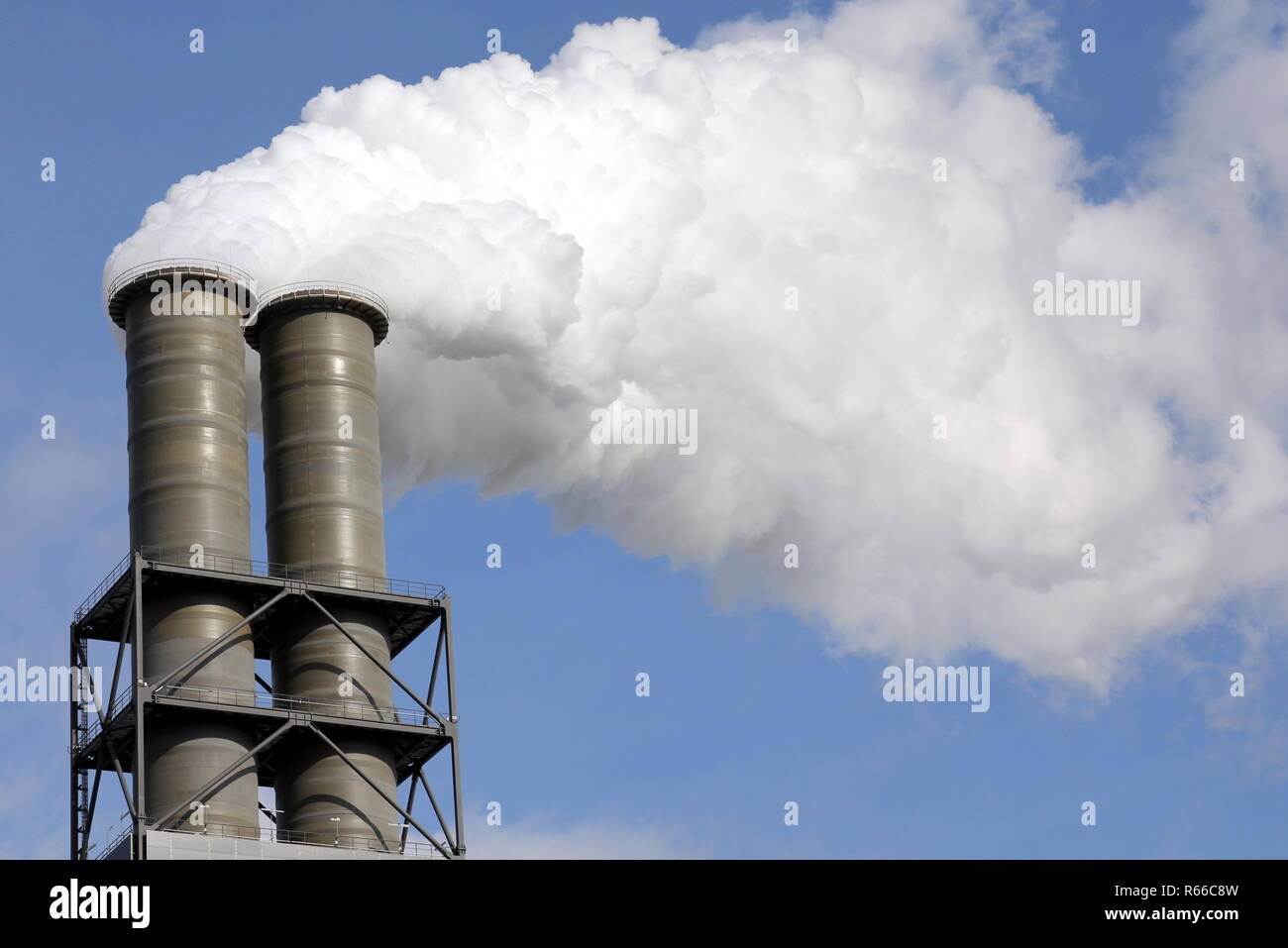 smoking industrial chimneys of a modern cogeneration plant Stock Photo ...