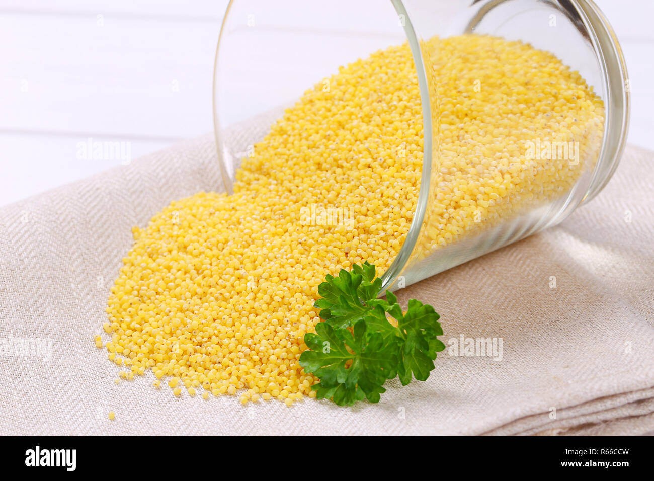 glass of raw millet grains Stock Photo - Alamy