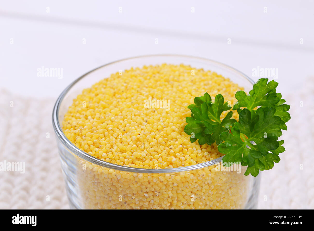 glass of raw millet grains Stock Photo - Alamy
