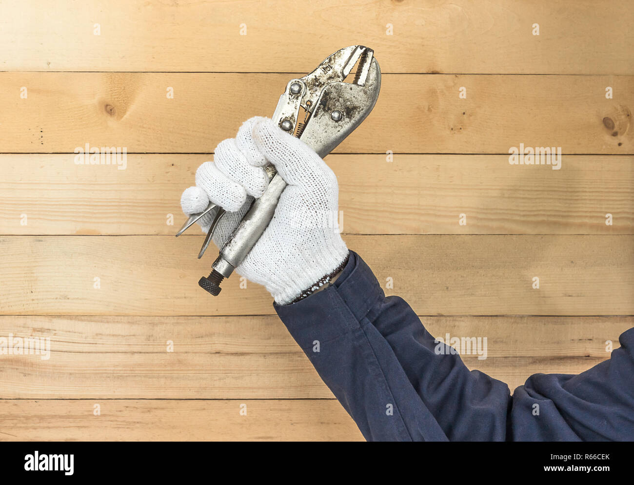 Hand in glove holding Adjustable wrench Stock Photo - Alamy