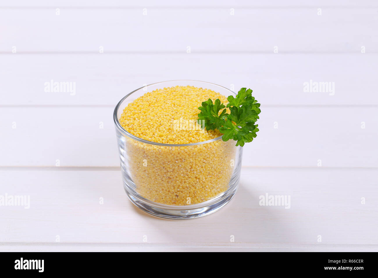 glass of raw millet grains Stock Photo - Alamy