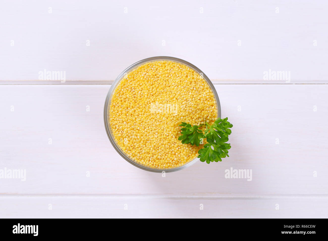 glass of raw millet grains Stock Photo - Alamy