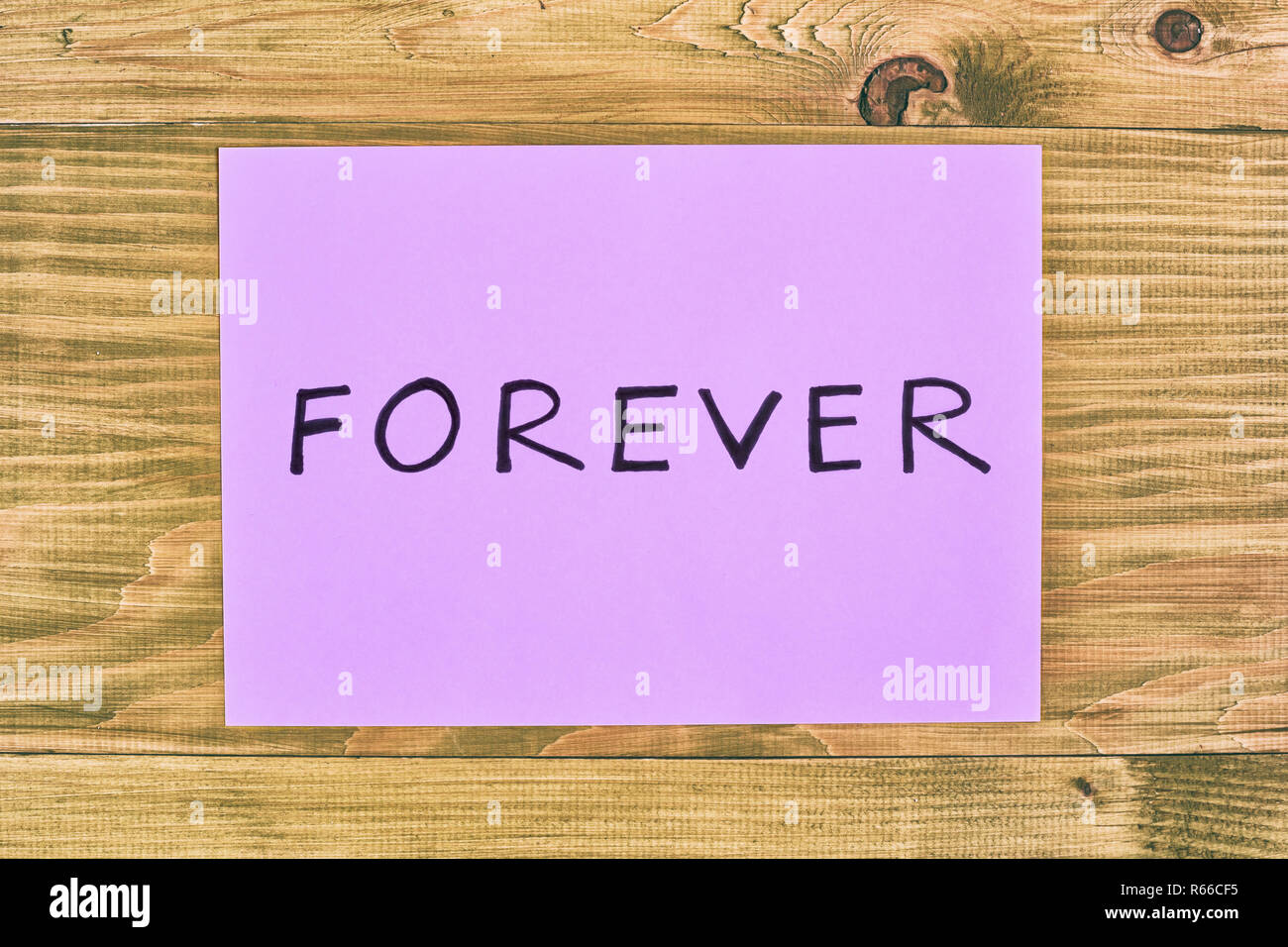 Paper with text forever on wooden table Stock Photo - Alamy