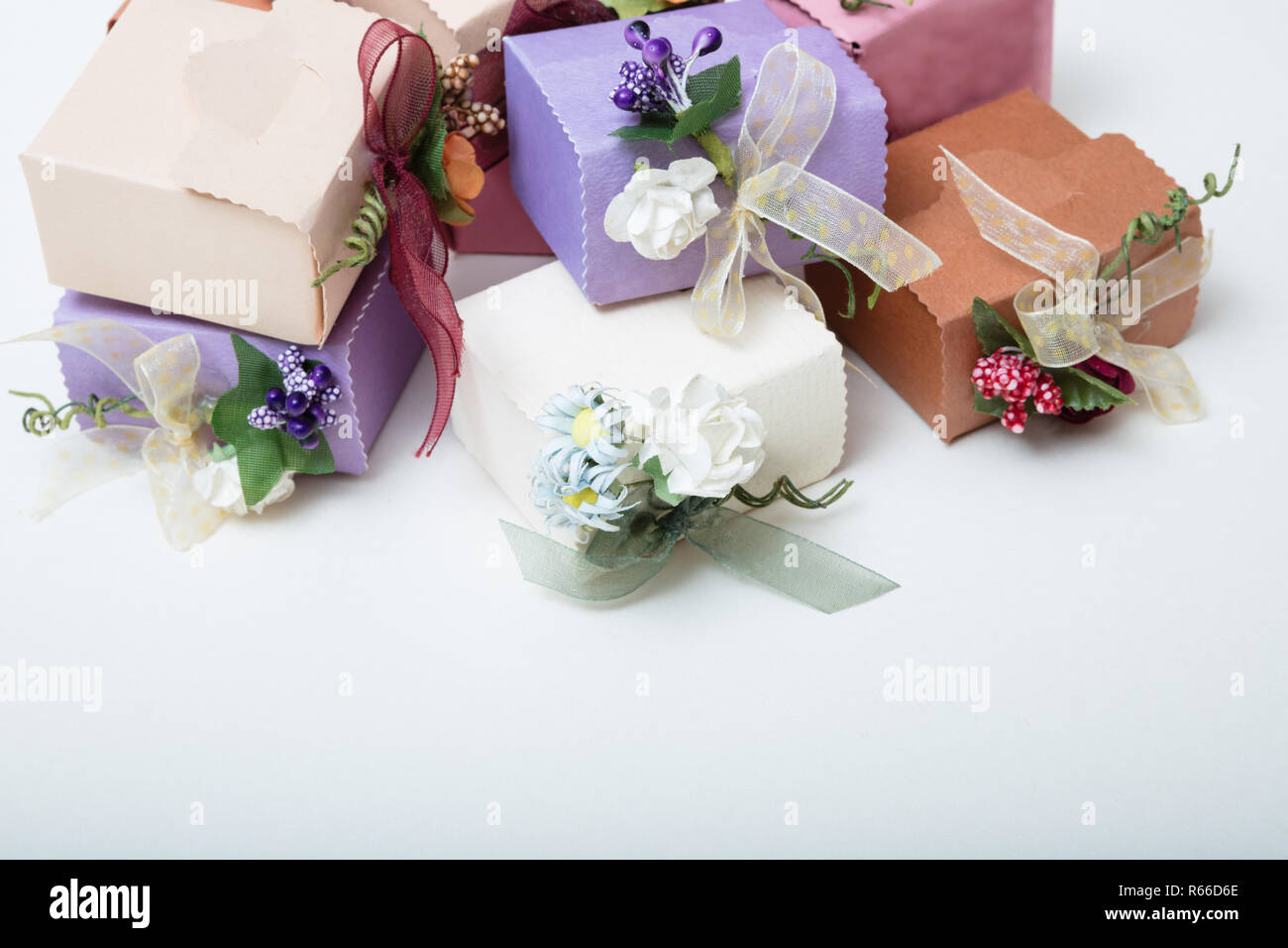 Pastel colours carton wedding gift boxes with ribbon and flowers with ...