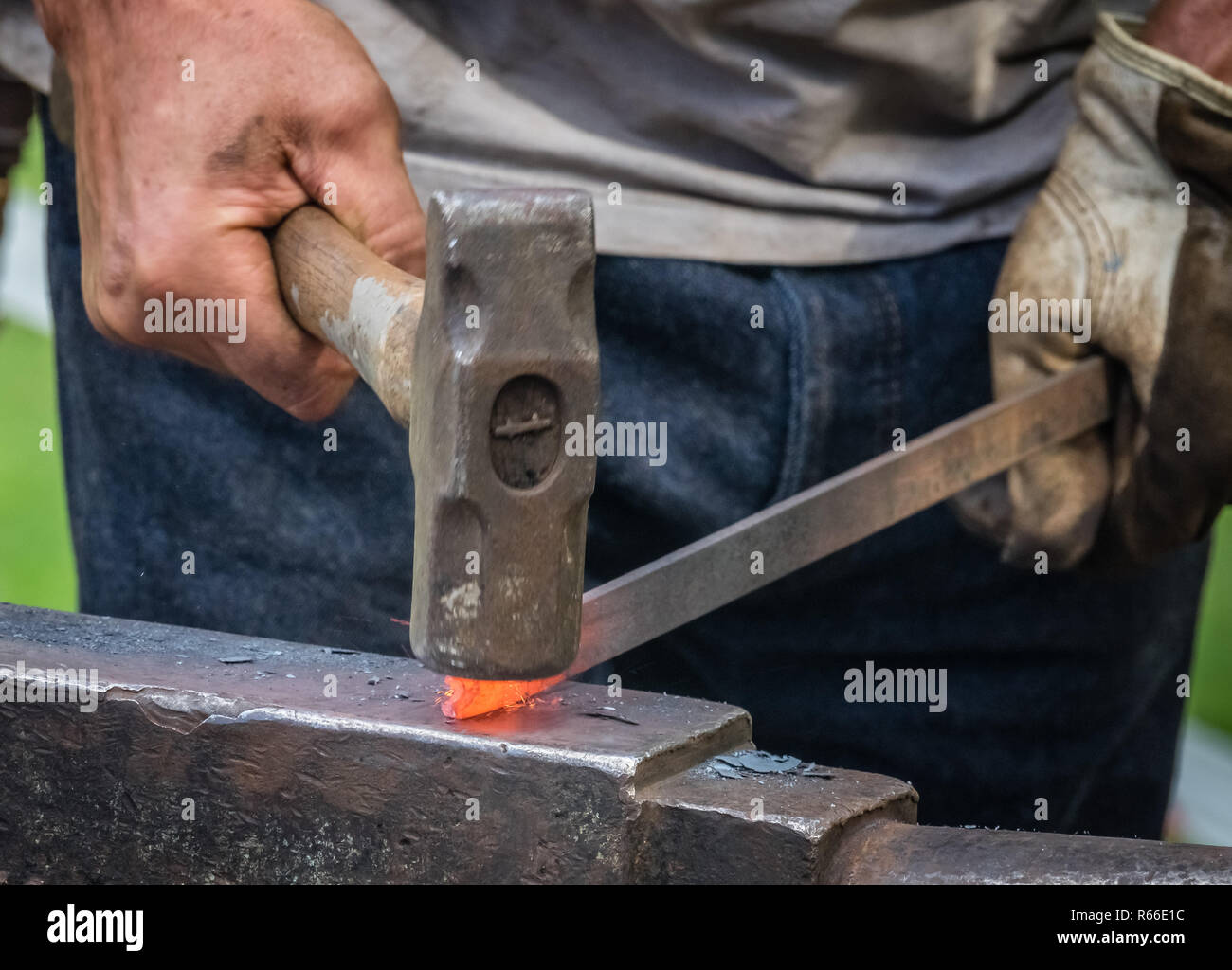 A blacksmith hammering hot iron Stock Photo - Alamy