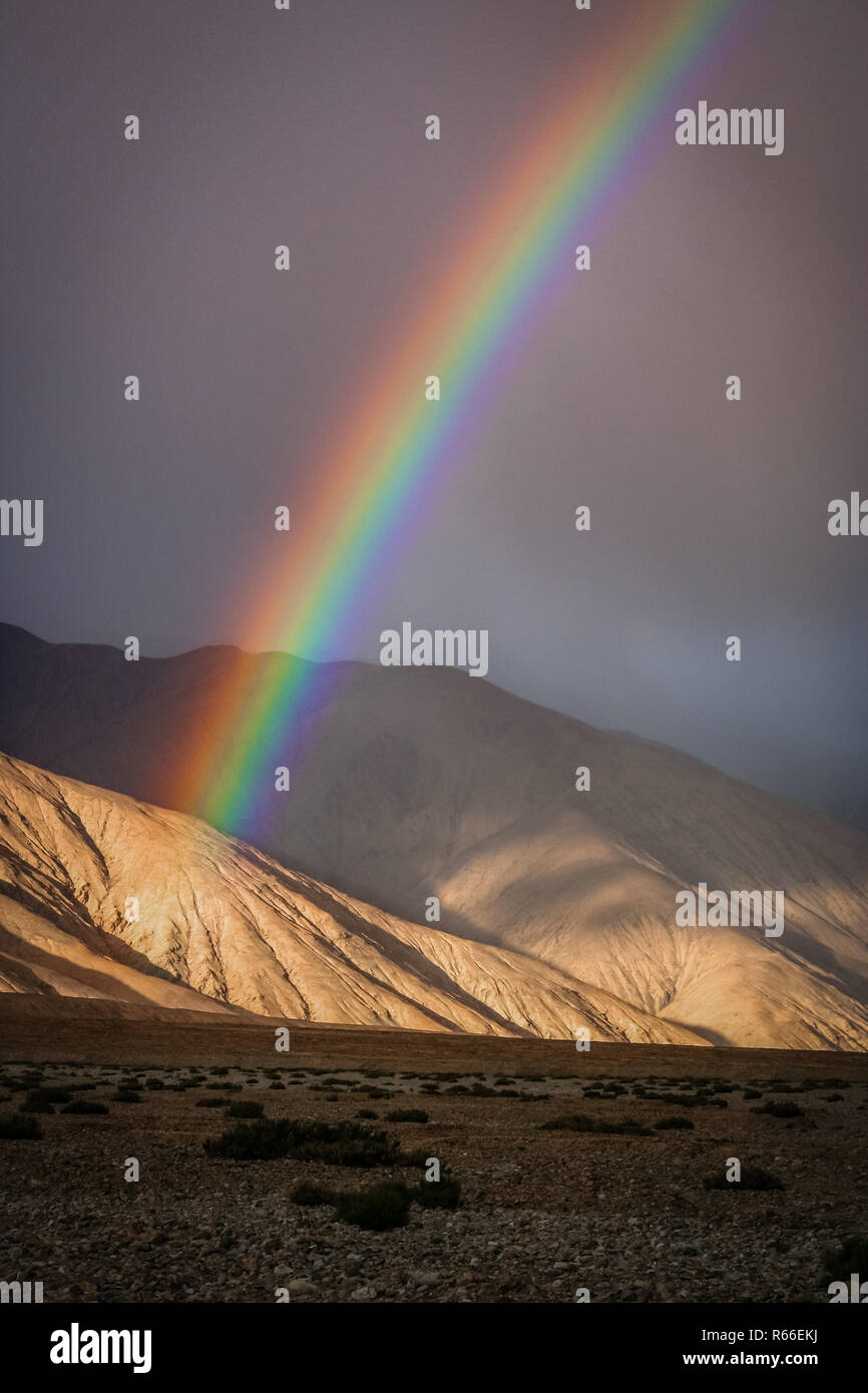 Colorful rainbow over mountains Stock Photo - Alamy