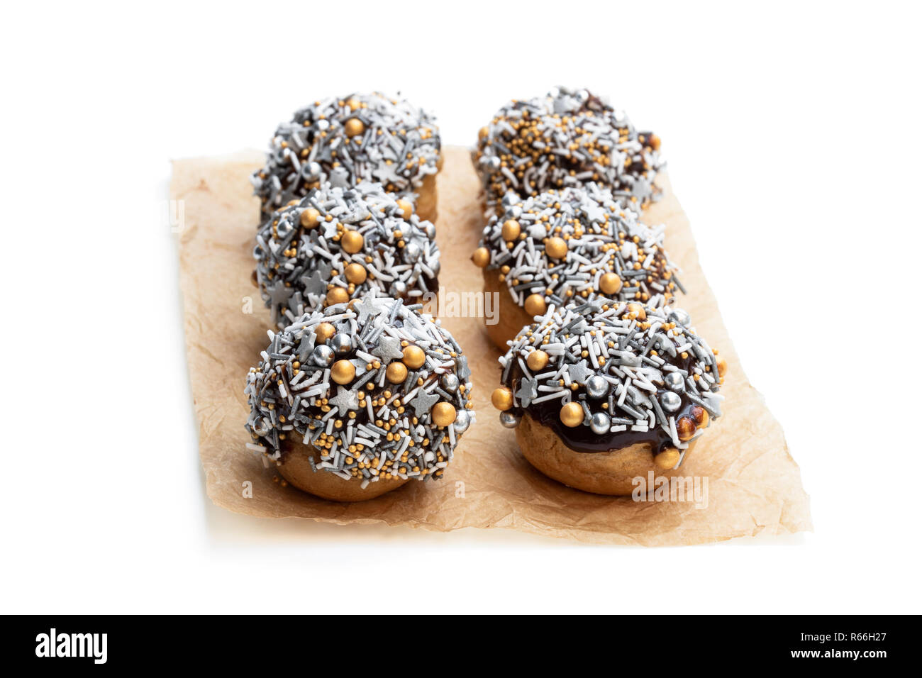 Homemade profiteroles covered with coloured sugar sparkles isolated on ...