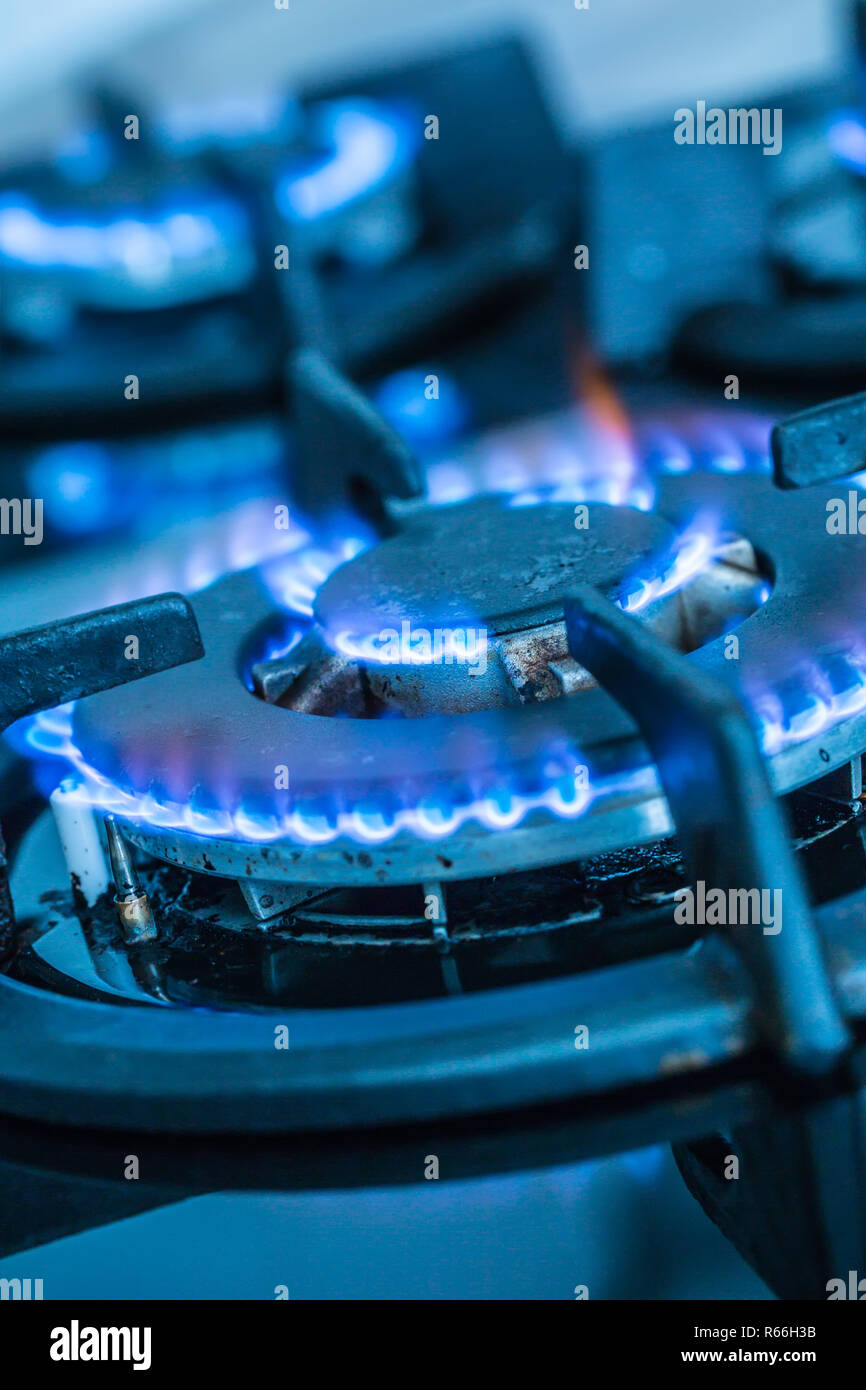 Close-up kitchen stove cook with blue flames burning Stock Photo - Alamy