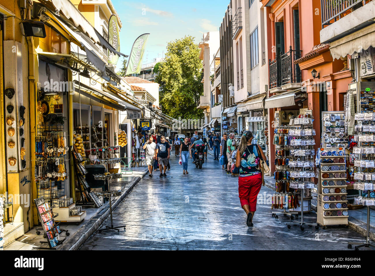 Tourists walk the streets lined with souvenir shops and outdoor ...