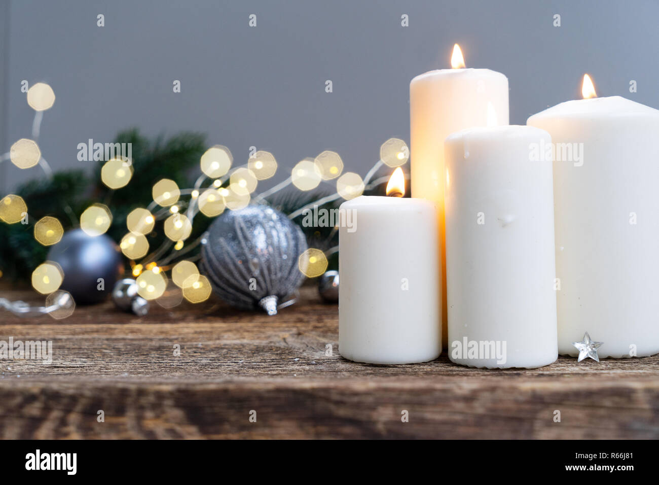 Elegant gray christmas scene with glowing candles on natural wood ...