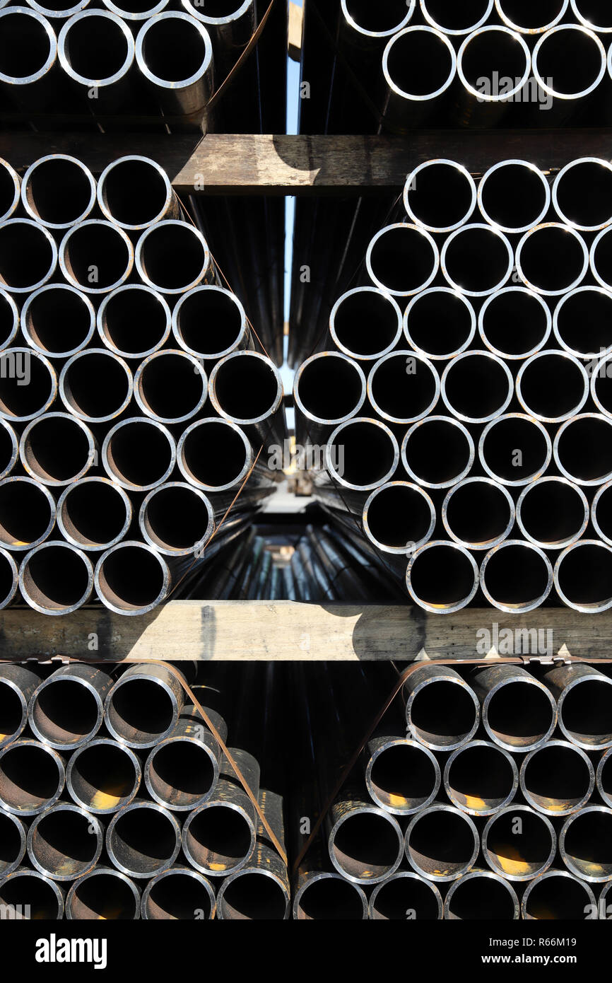 Stack of steel pipes industrial background Stock Photo - Alamy