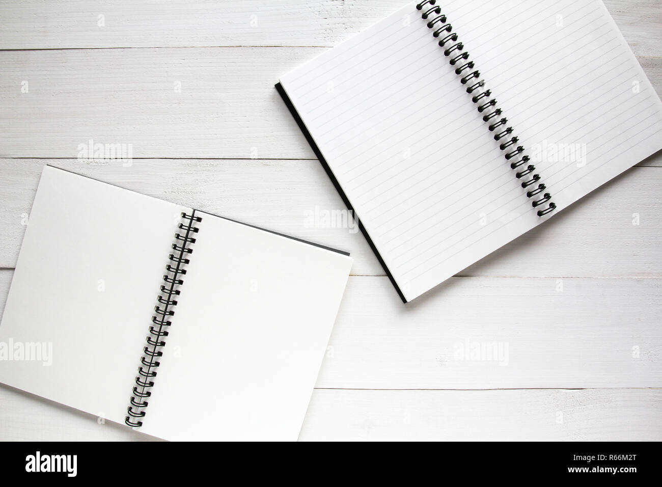 Notebook on white wooden table background Stock Photo - Alamy