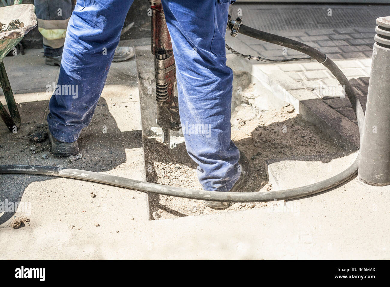Hammer drill breaking sidewalk asphalt Stock Photo - Alamy
