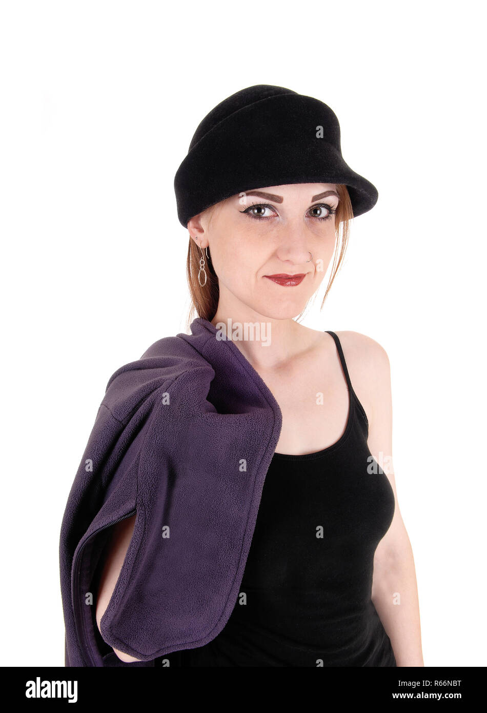 Woman with hat and coat over her shoulder Stock Photo - Alamy