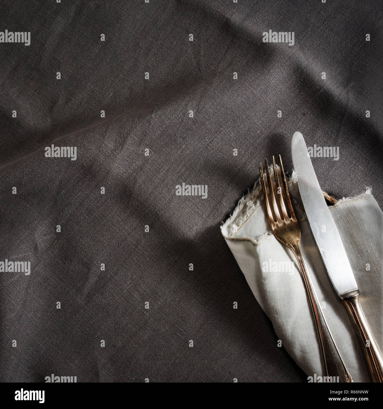 black linen tablecloth with fine silver cutlery Stock Photo - Alamy