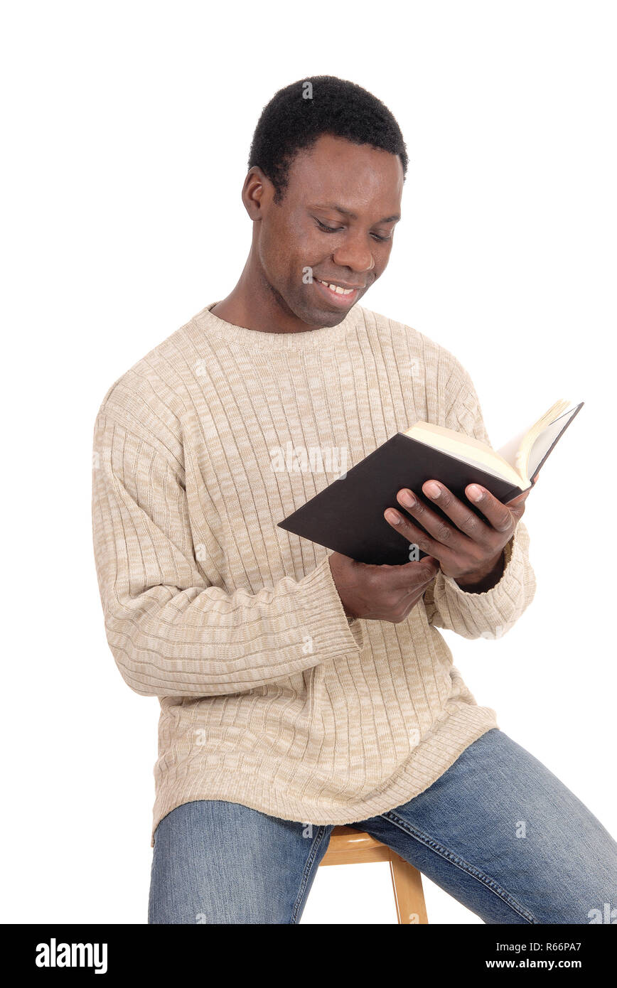 African man sitting and reading his book Stock Photo - Alamy