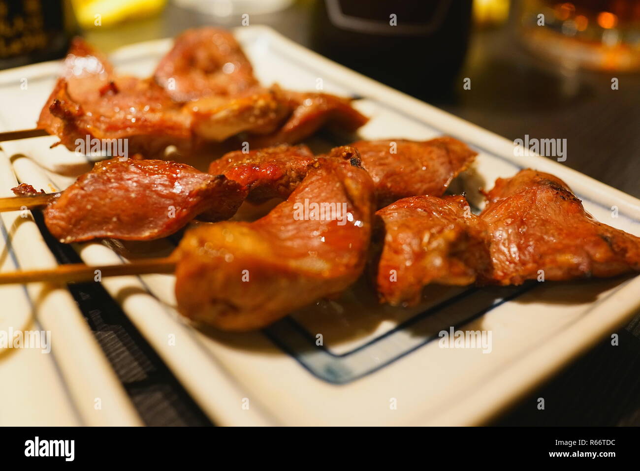 Close-up of grilled chicken kidneys and hearts yakitori on bamboo ...