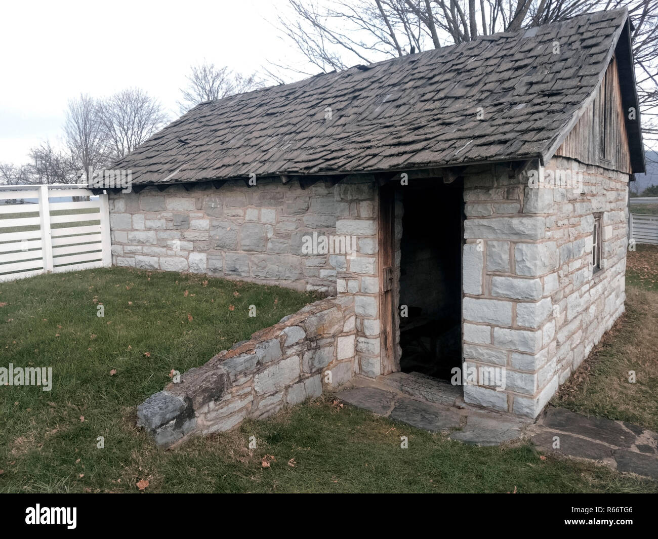 Stone outbuilding with weathered wooden shingles Stock Photo - Alamy