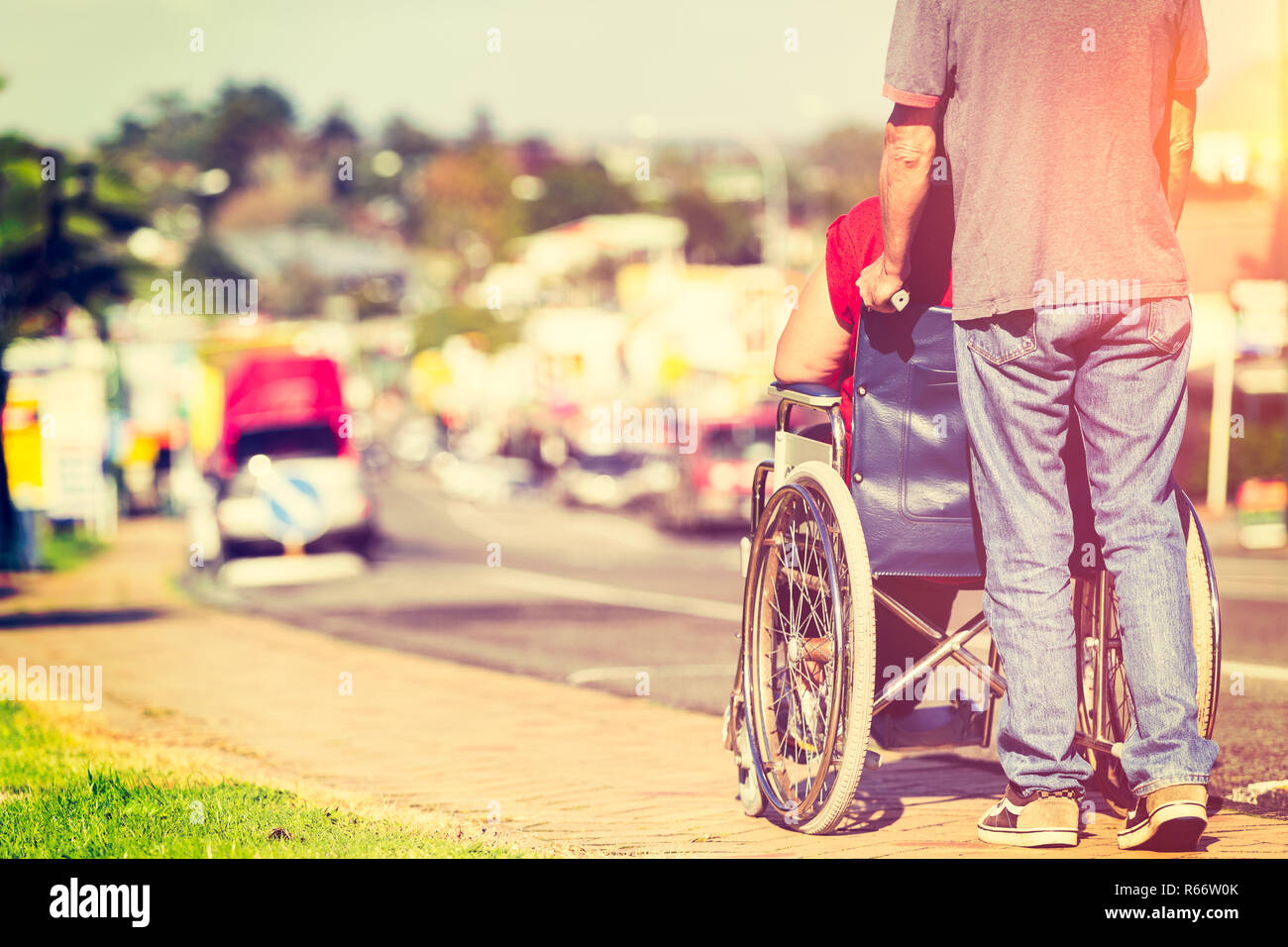 Man Pushing Wheelchair Stock Photo - Alamy