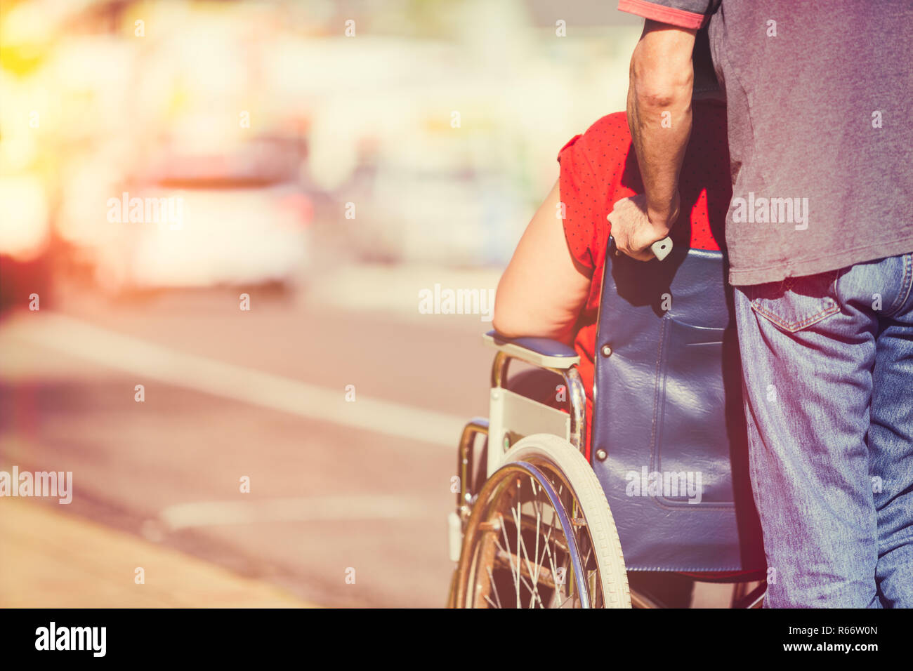 Man Pushing Wheelchair Stock Photo - Alamy
