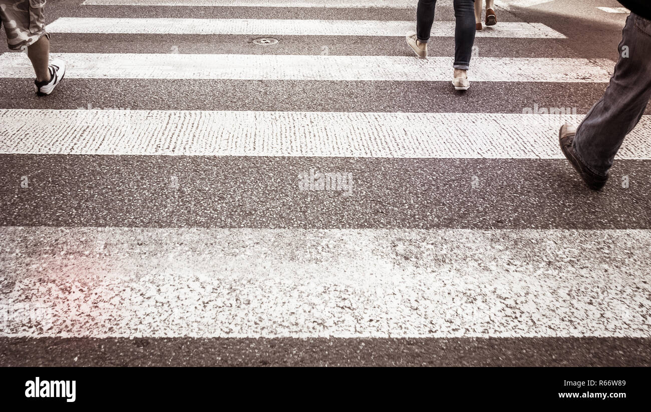 People crossing the road in town Stock Photo - Alamy