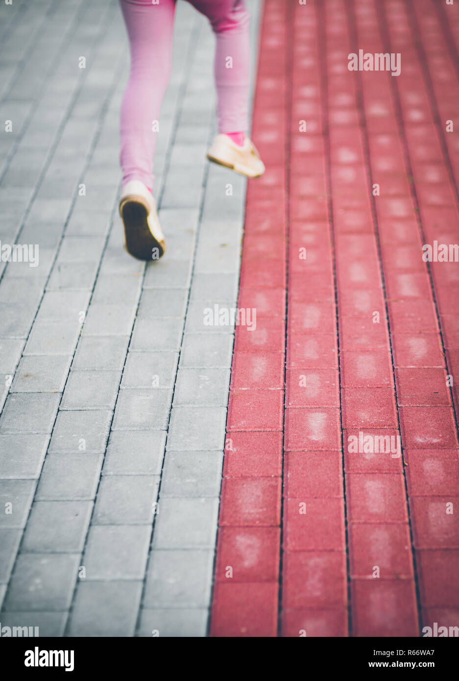 Little girl running on the pavement Stock Photo - Alamy