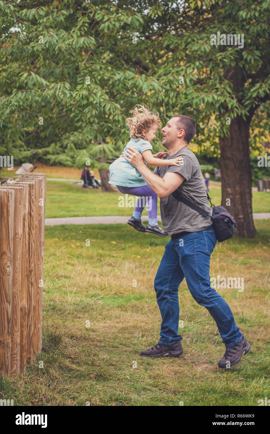 Father catching daughter Stock Photo - Alamy