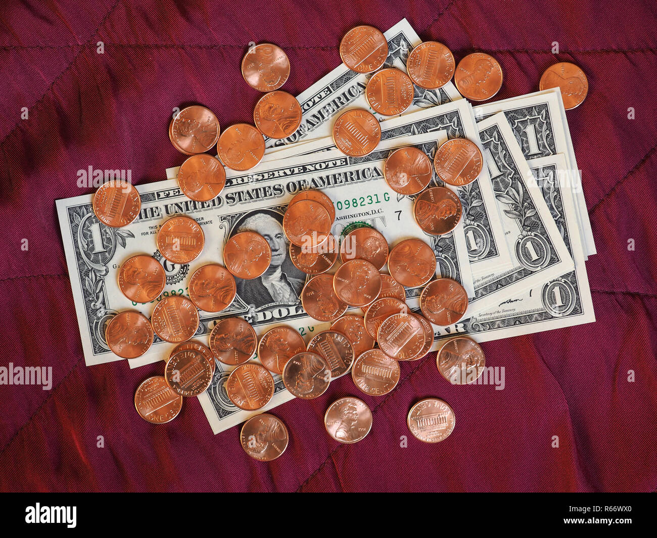 Dollar notes and coin, United States over red velvet background Stock ...