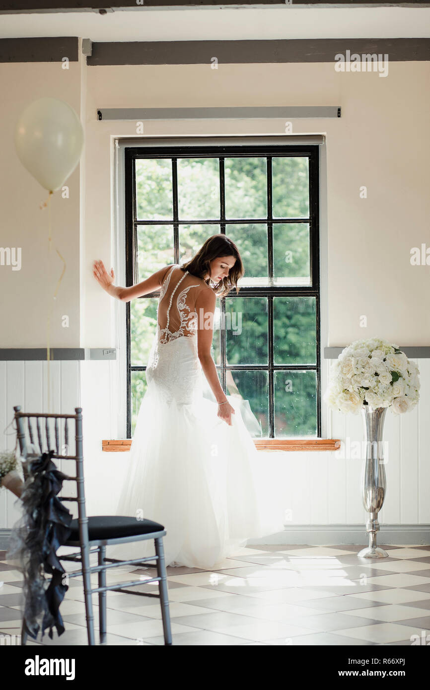 Beautiful Bride Posing At The Window Stock Photo - Alamy