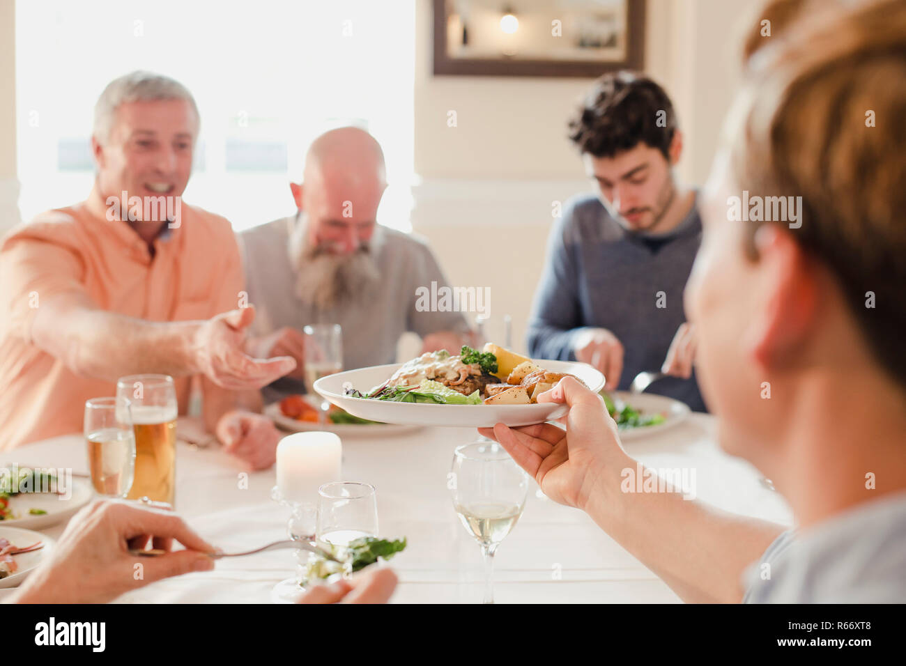 Passing A Plate At The Dinner Party Stock Photo - Alamy