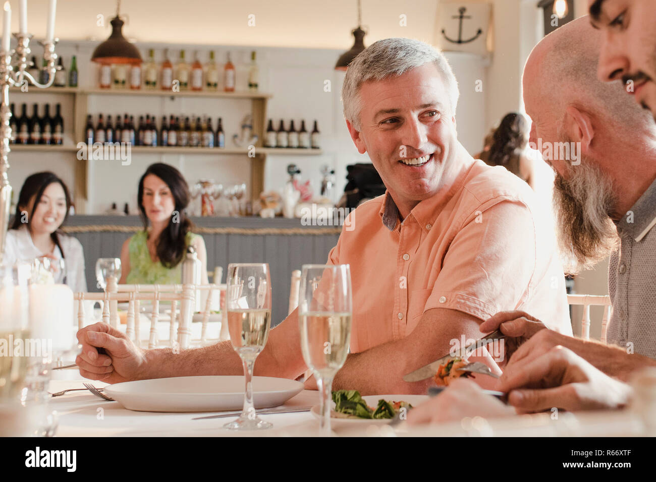 Senior Men Socialising At A Dinner Party Stock Photo - Alamy