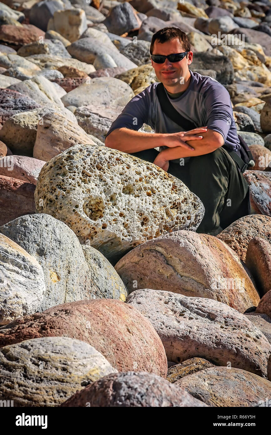 Guy sitting on rocks hi-res stock photography and images - Alamy
