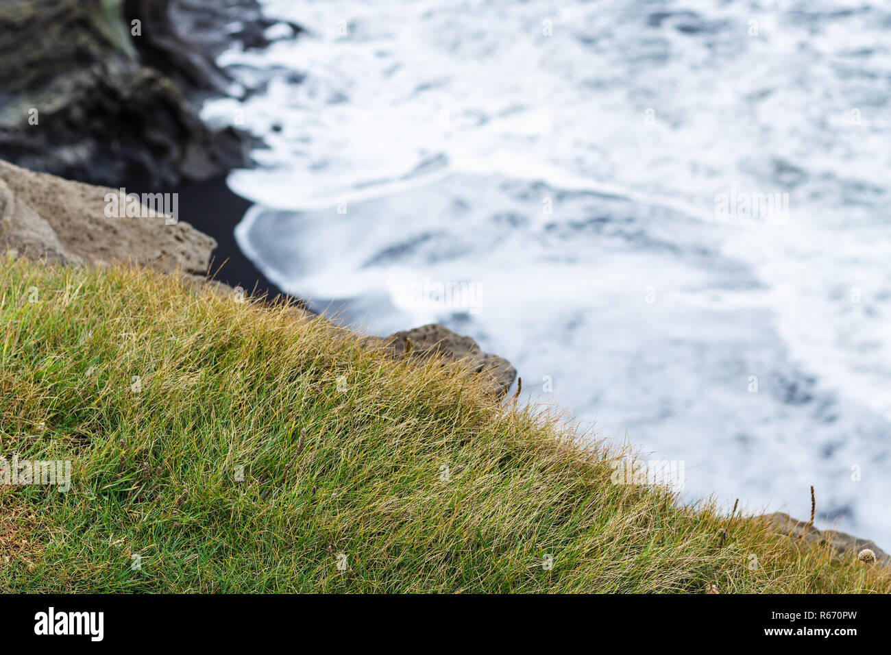 green grass on edge of cliff in Iceland Stock Photo - Alamy