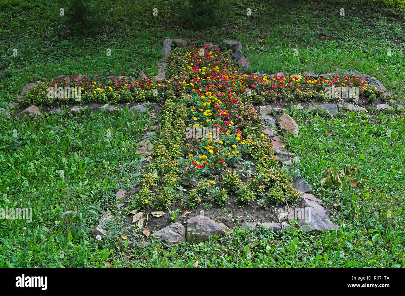 Cross made out of flowers and rocks in etno park Stock Photo - Alamy