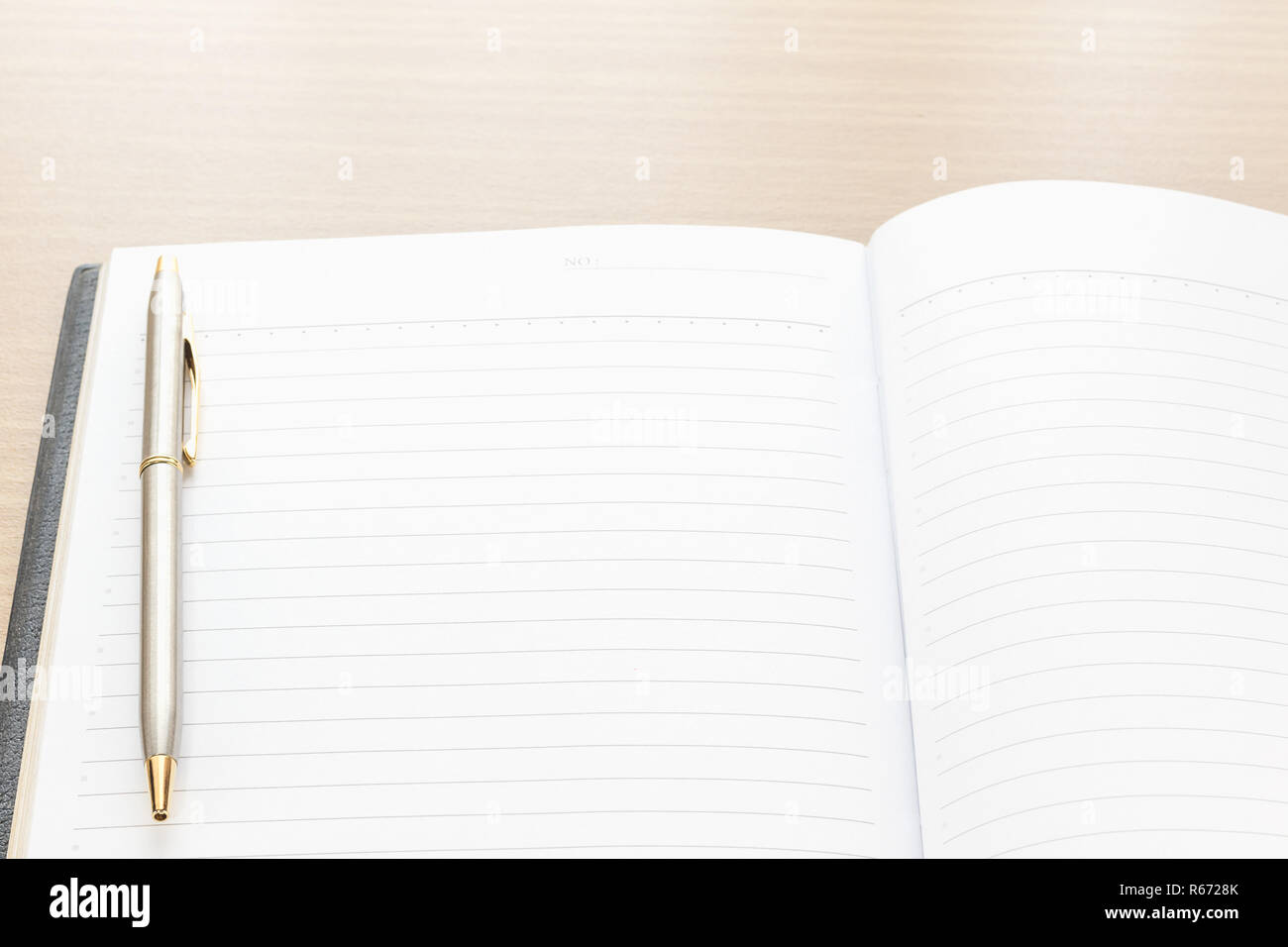 Pen put on notebook open blank page Stock Photo - Alamy
