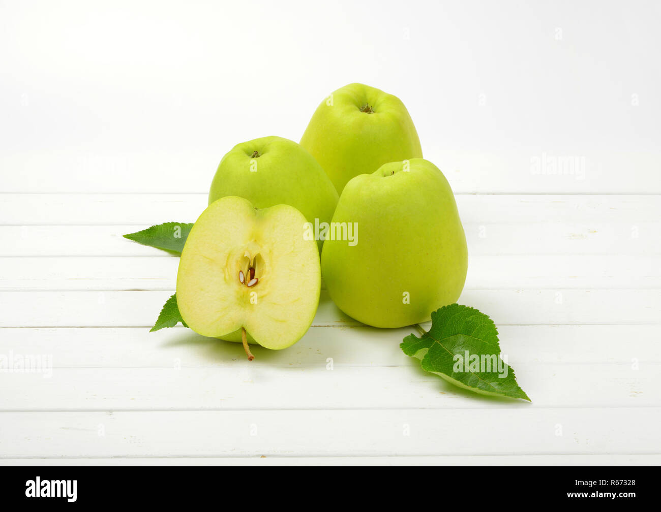 Three and a half green apples Stock Photo - Alamy