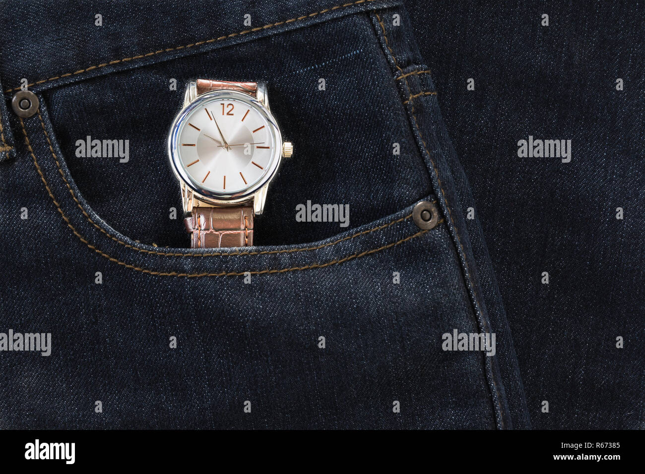 Wristwatch in denim jeans pocket Stock Photo - Alamy