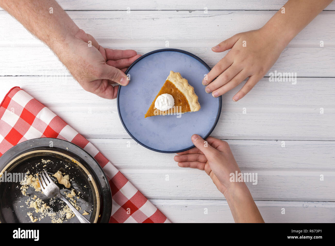 An overview of hands reaching for the last piece of pumpkin pie Stock ...