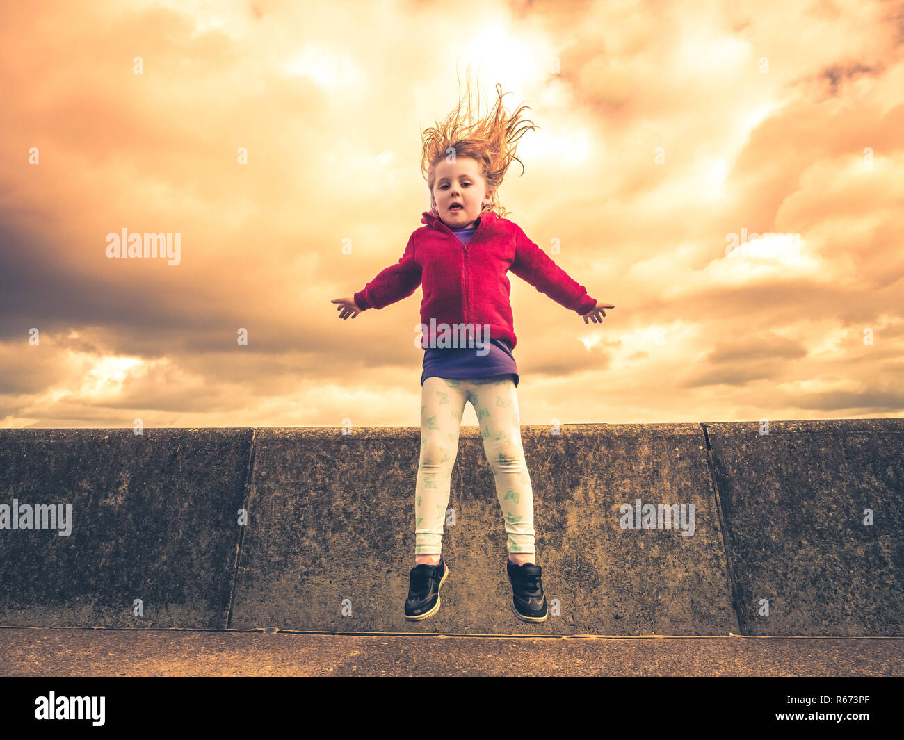 Little girl jumping high Stock Photo - Alamy