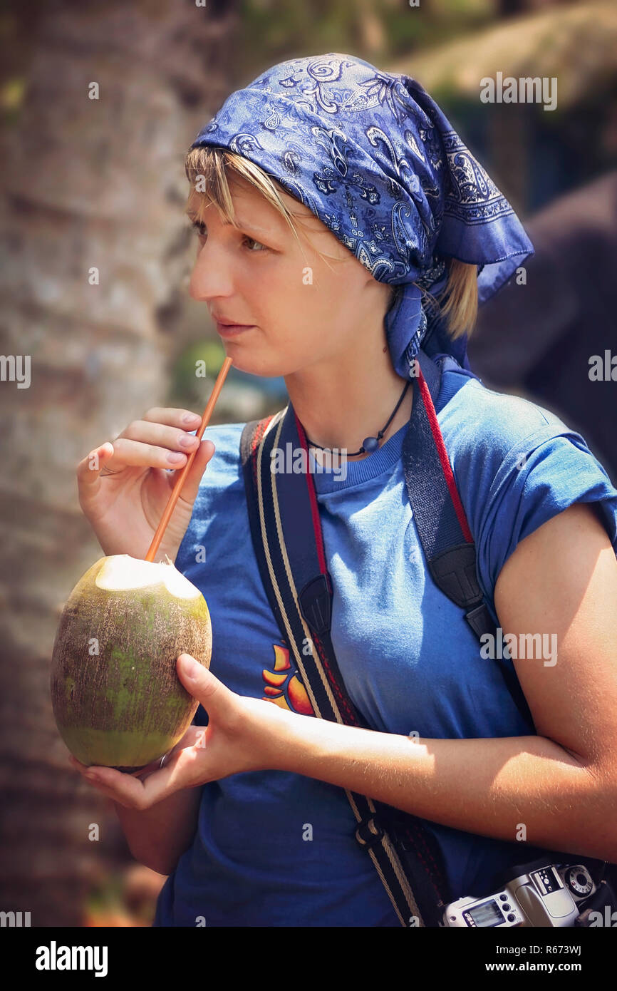 Drinking coconut juice Stock Photo - Alamy