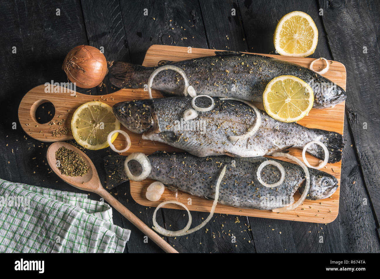 Fresh fish seasoned with herbs and lemons Stock Photo - Alamy
