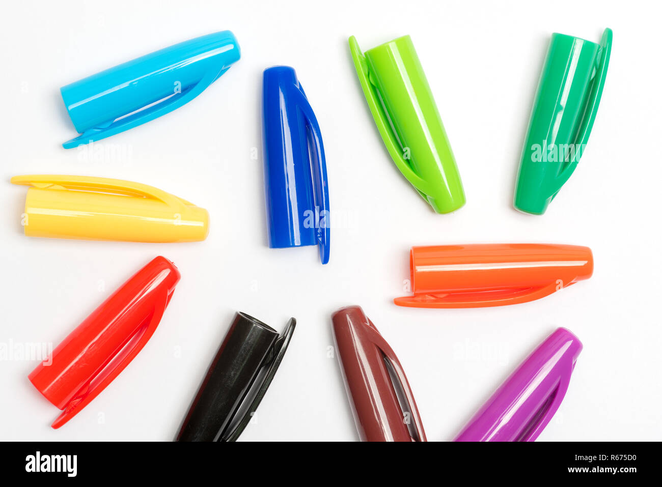 Colourful plastic pen lids on white background Stock Photo - Alamy