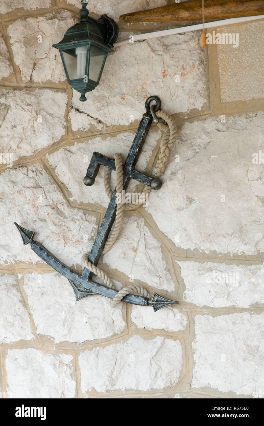 an old anchor still hanging on the wall Stock Photo - Alamy