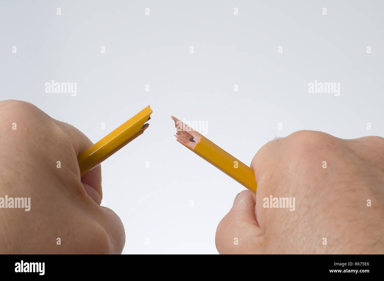 a broken pencil in his hands Stock Photo - Alamy