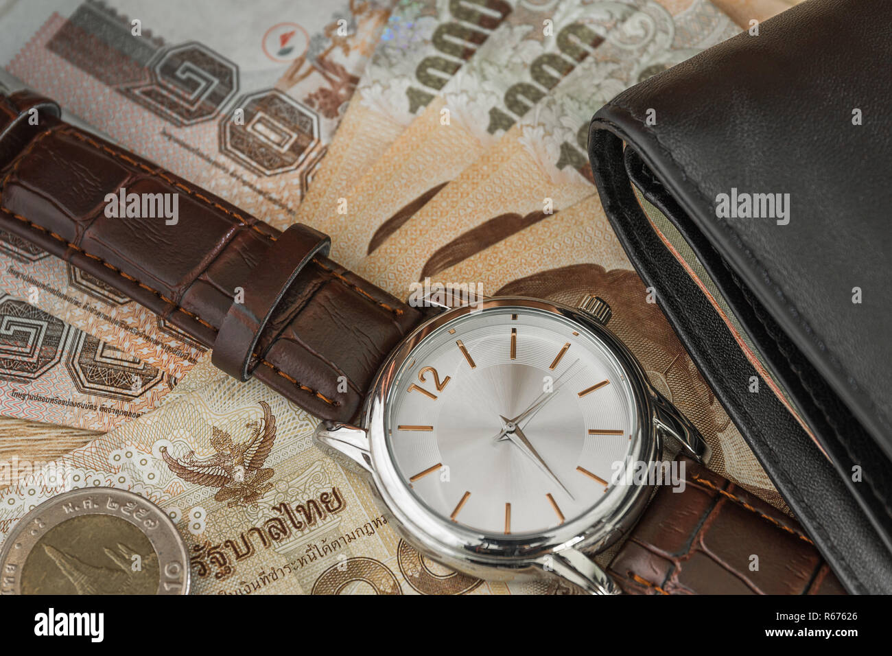 Watch and wallet on banknote Stock Photo - Alamy