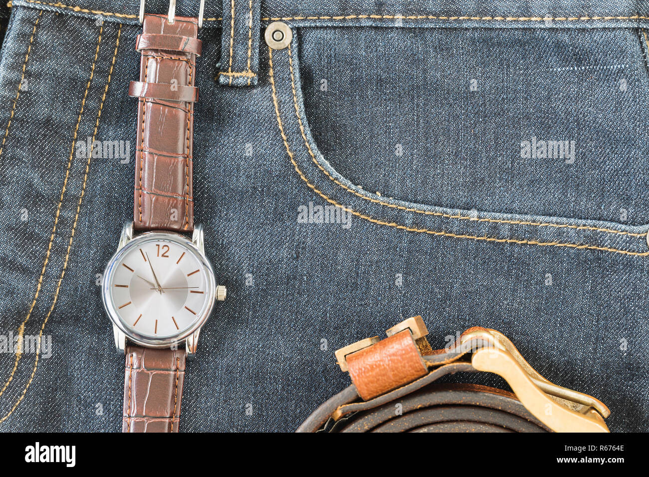 Wrist watch and leather belt on jeans Stock Photo - Alamy