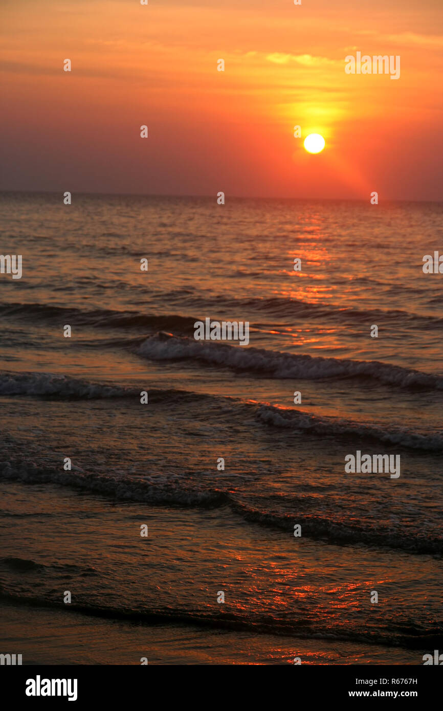 Sunset on the beach Stock Photo - Alamy